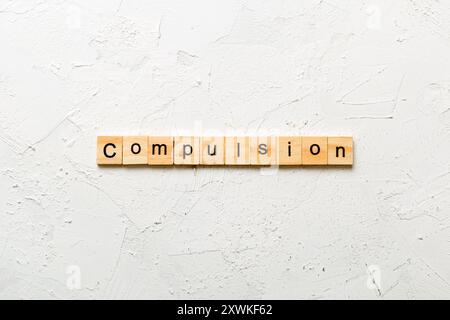 compulsion word written on wood block. compulsion text on table ...