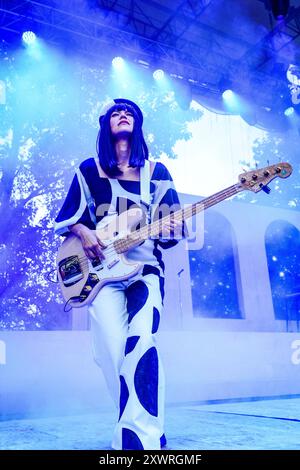 Bassist Laura Lee of Khruangbin on stage wearing a red floral mini ...