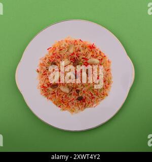 Colourful Asian Zarda rice on a white plate pink background Stock Photo ...