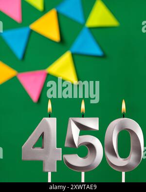 Green candle number 450 - Birthday card on pastel pink background Stock ...
