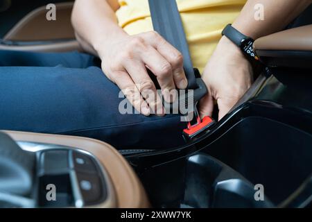 Fastening Seat Belt to lock seat belt in car. Woman hand Close up Stock ...