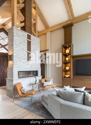 Living room with beamed cathedral ceiling and large stone fireplace ...