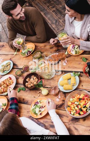 Four friends having dinner, top view Stock Photo - Alamy