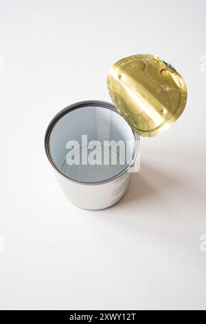 Open lid, unlabeled tin can on white background. Close up shot, no ...
