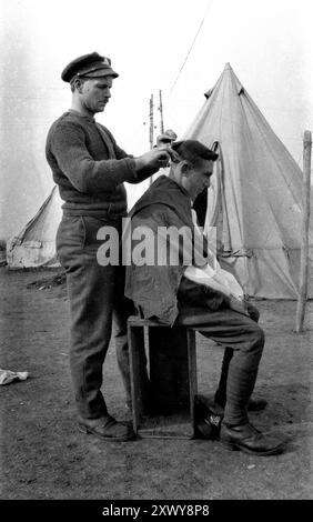 Royal Artillery soldier getting a military style hair cut in France 1915 during First World War ...
