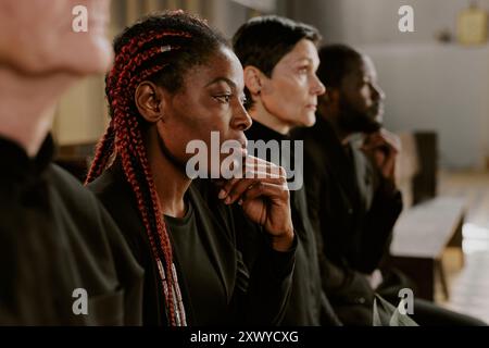 Mournful African American woman dressed in total black with eyes full ...