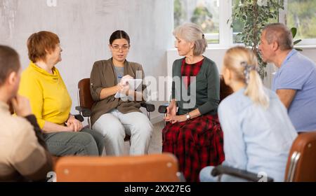 A young female teacher counseling students learning Stock Photo - Alamy