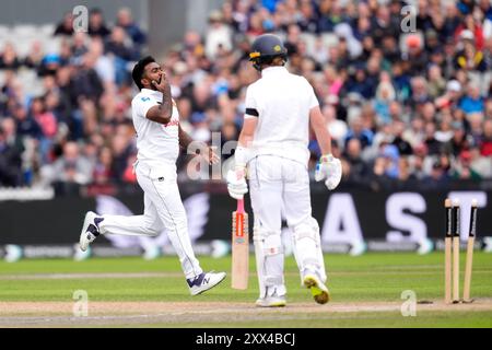 Sri Lanka's Asitha Fernando (left) celebrates bowling out England's ...