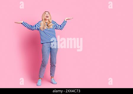 Photo of funny impressed young lady wear red clothes pointing thumb up ...