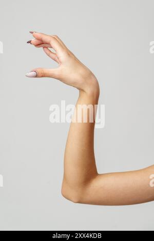 Woman's Arm Extended With Hand Open and Fingers Against a White ...