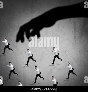 Silhouette of big hand catching scared small businessman on grey ...