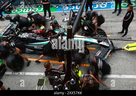 Mercedes pit crew members practice at the pits at the Suzuka Circuit in ...