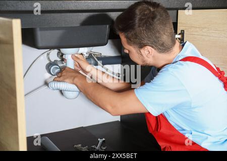 Professional plumber fixing piping system at home Stock Photo - Alamy