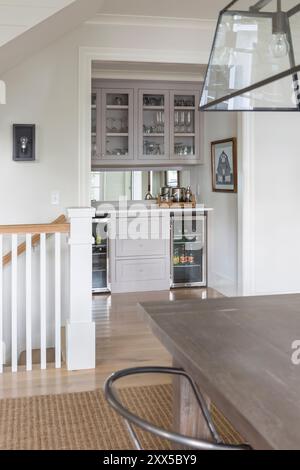 Dining room with glass display cabinets framing open balcony doors ...