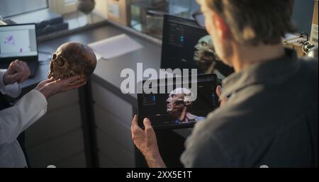 Two archaeologists study fossil skull, create 3D model of prehistoric ...