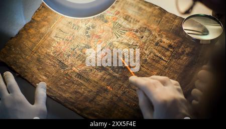 Two scientists examine ancient Egyptian papyrus together in ...