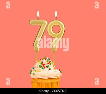 Golden birthday candle number 79 with cupcake - White block wall ...