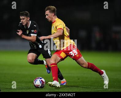 Grimsby Town's Denver Hume in action with Barrow's Kian Spence during ...