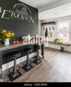 Kitchen counter with food and blackboard painted wall with drawing and ...