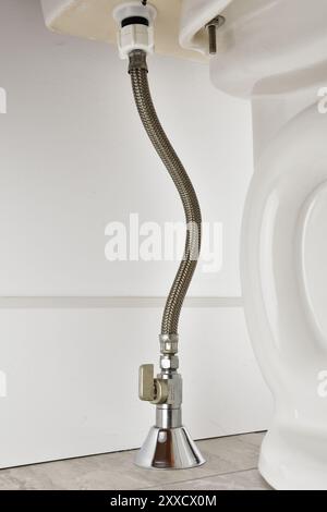 Toilet water feed line. Water valve on toilet inlet with braided hose ...