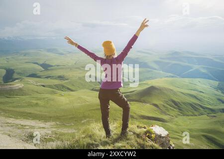 Young woman feeling strong and confident on the outdoor against green ...