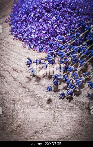 Bunch of dry lavender scented sea salt on wooden board healthcare ...