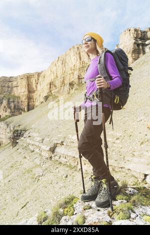 Girl Traveler hiking with backpack at rocky mountains landscape Travel ...