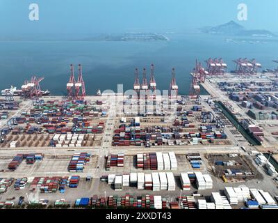 Cargo ships load and unload containers in an orderly manner at the ...