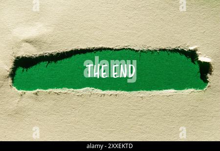The end message written on ripped torn paper piece with green ...