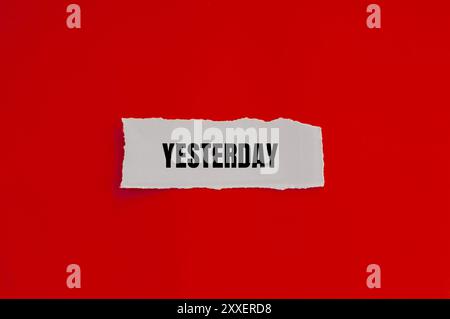 Yesterday word written on torn paper with red background. Conceptual ...