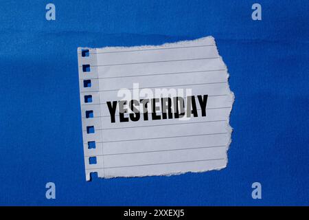 Yesterday message written on ripped torn yellow paper piece with green ...