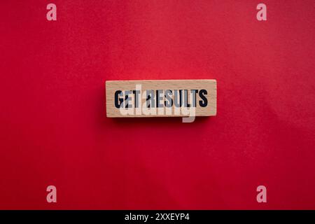 Get results message written on wooden blocks with orange background ...