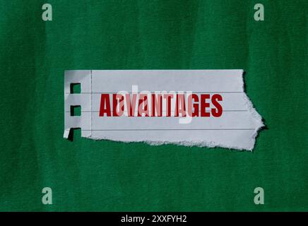 Advantages message written on ripped torn paper with cardboard ...