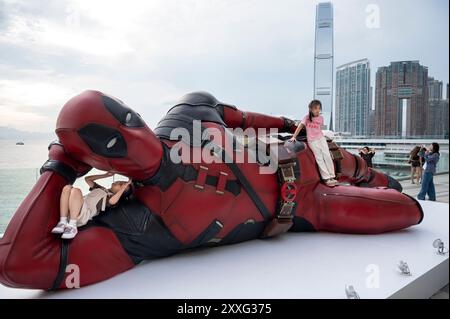 Children climb an 8-meter installation of Marvel's Deadpool character ...