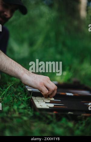 Man enjoying an outdoor backgammon game in a park Stock Photo - Alamy