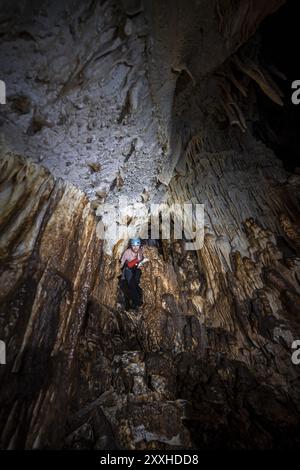 Woman exploring stalactite cave, Terciopelo Cave, Barra Honda National ...