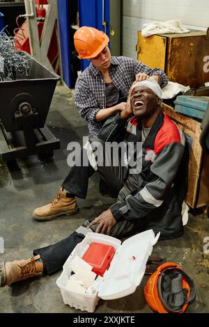Injured worker at the work site Stock Photo - Alamy