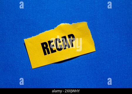 Recap message written on ripped torn paper piece with blue background. Conceptual recap symbol ...