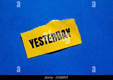 Yesterday message written on ripped torn yellow paper piece with green ...