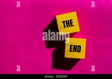 The end message written on yellow wooden cubes with green background ...