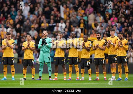 Players and fans stand for a minutes applause in memory of Rod Petrie ...
