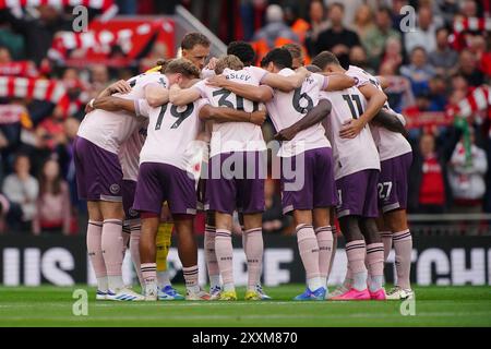 Liverpool players form a huddle ahead of the Premier League match at ...