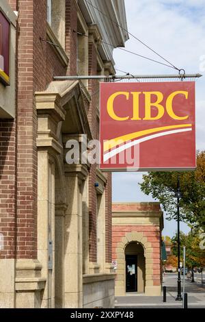 A CIBC bank sign hangs from a building in southern Alberta, Canada ...