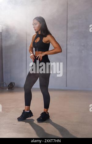 Tired millennial european woman athlete in sportswear checks pulse on ...
