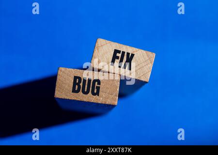 Bug fix message written on wooden blocks with blue background ...