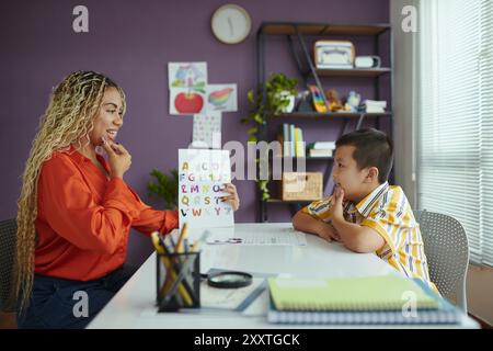 Teaching Alphabet with Colorful Chart in Classroom Stock Photo - Alamy