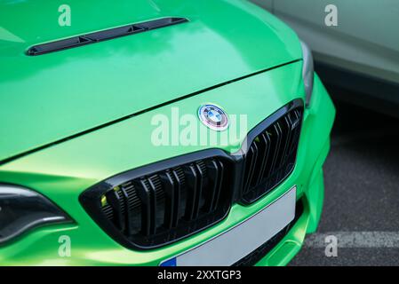 Vibrant green BMW M2 parked on street, showcasing sleek design and bold ...