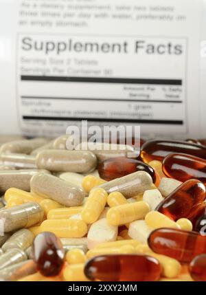 Composition with dietary supplement capsules and containers Stock Photo ...