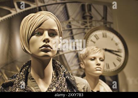 Two mannequins and a clock Stock Photo - Alamy