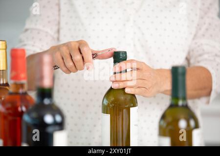 hand broaching bottles of wine Stock Photo - Alamy